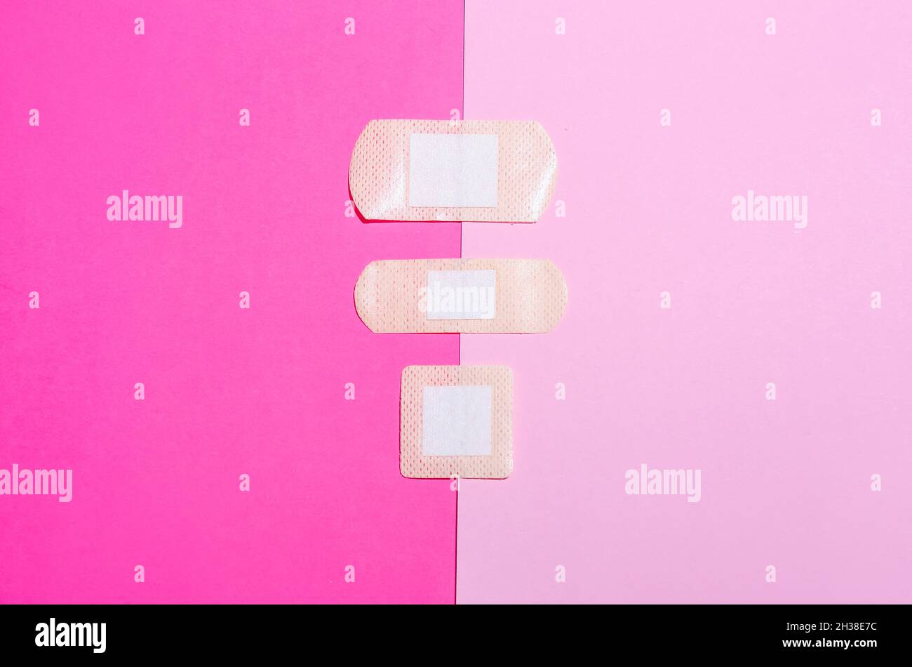 Adhesive medical plasters on pink background Stock Photo - Alamy