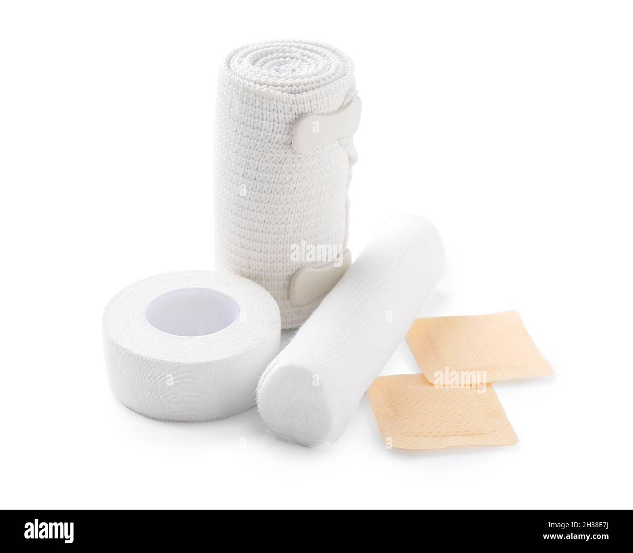 Medical plasters, gauze rolls and elastic bandage on white background ...