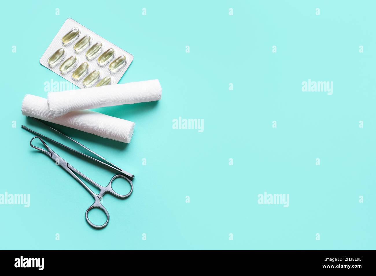 Surgical tools, gauze rolls and pills on color background Stock Photo ...