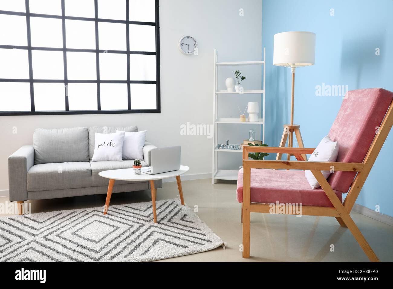 Armchair and comfy sofa in room with modern window and color wall Stock ...