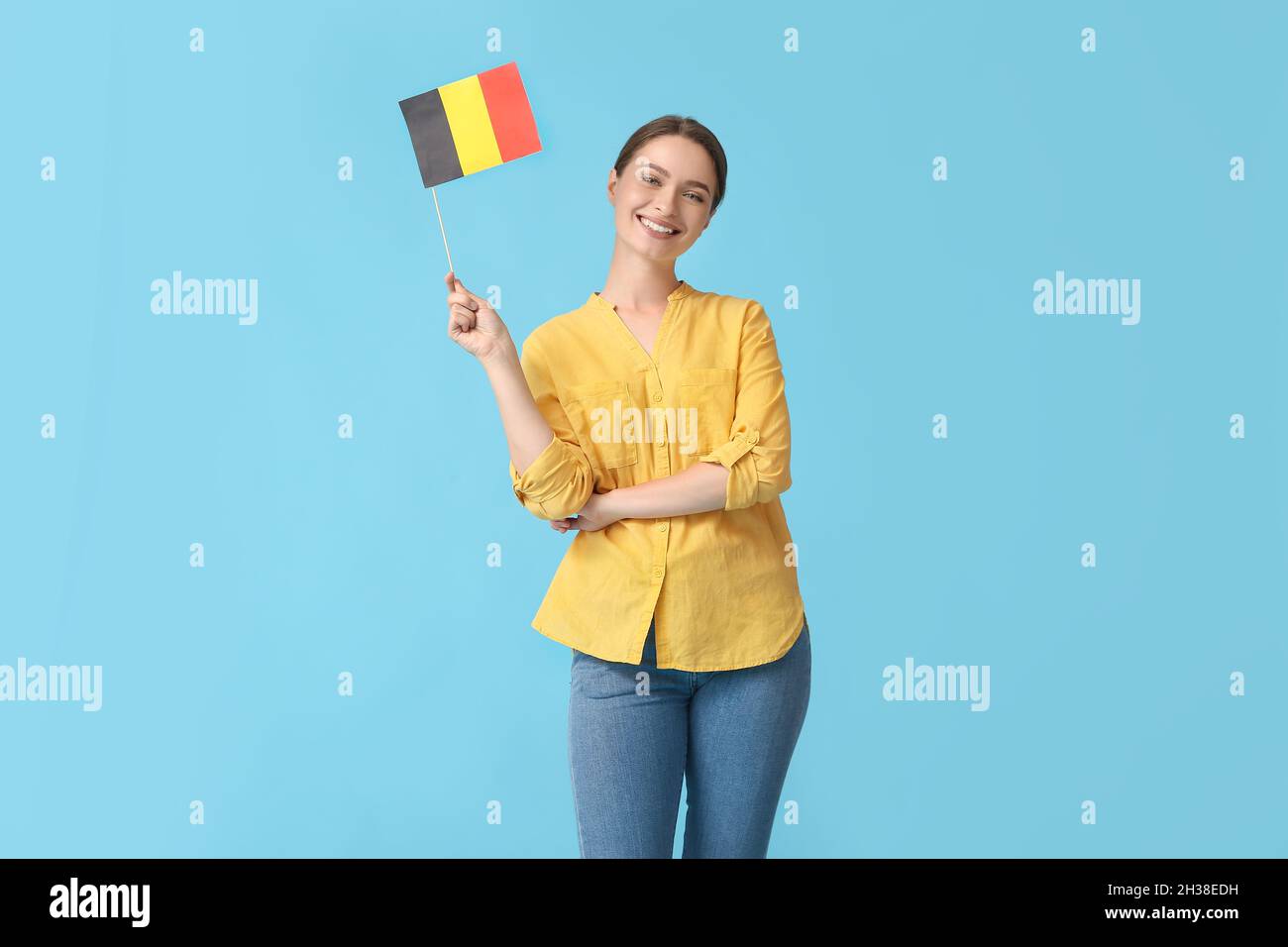 Young woman with flag of Belgium on color background Stock Photo - Alamy