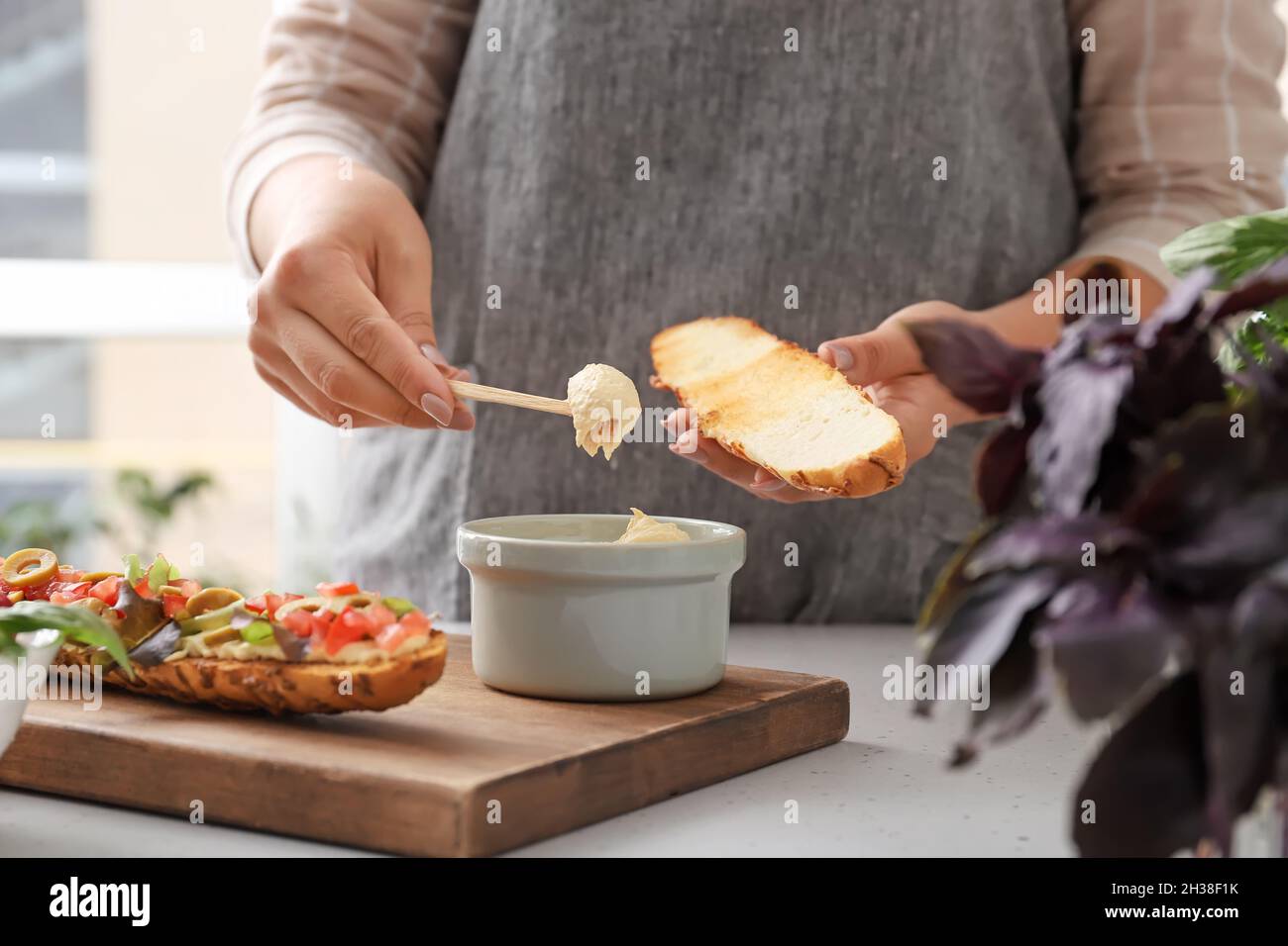 Woman eating vegetables with hummus hi-res stock photography and images ...
