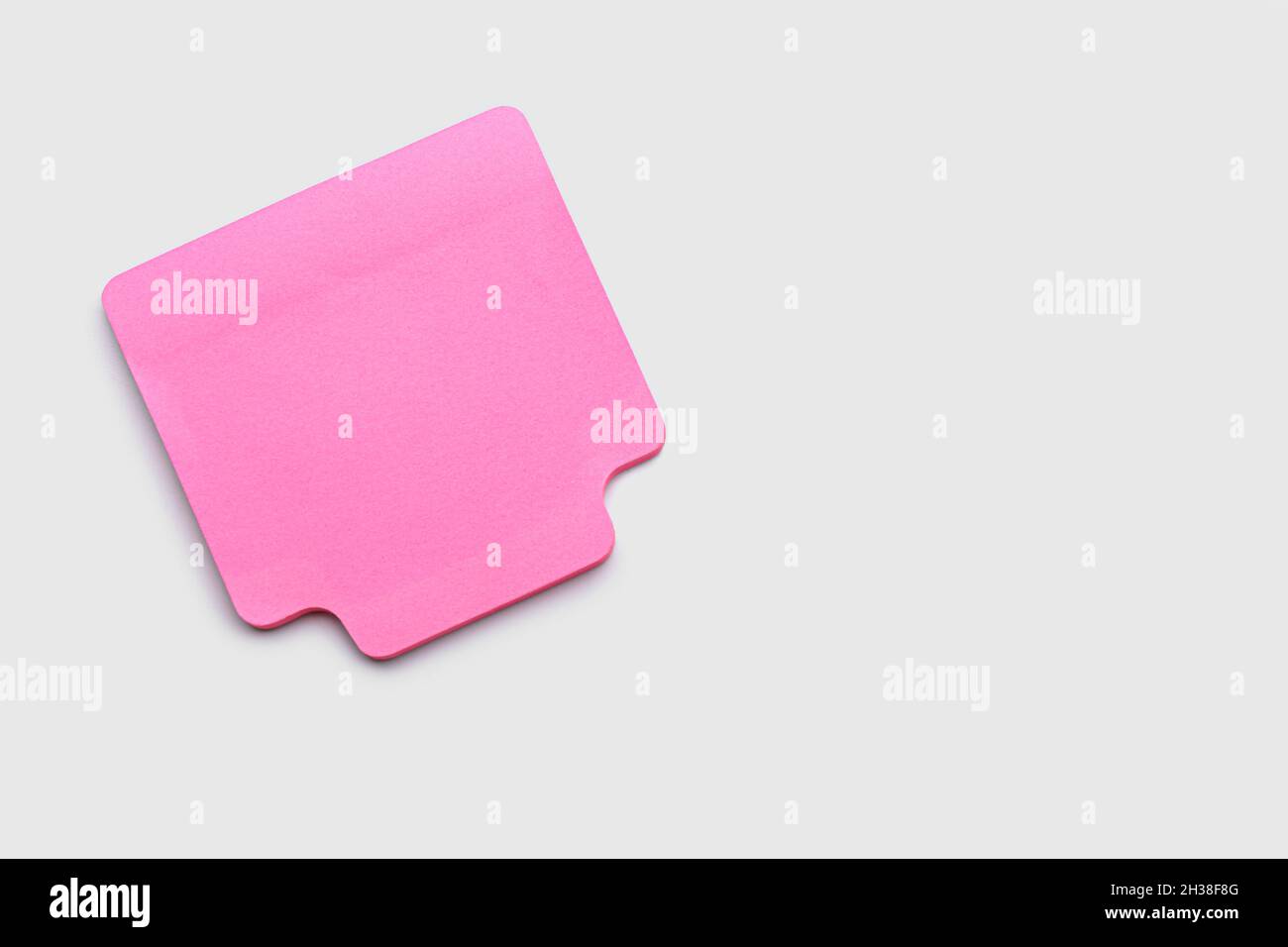 Pink sticky note on white background Stock Photo - Alamy