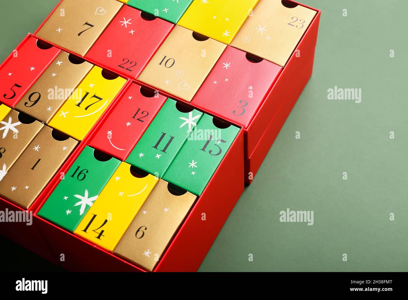 Winter advent calendar on green background Stock Photo - Alamy