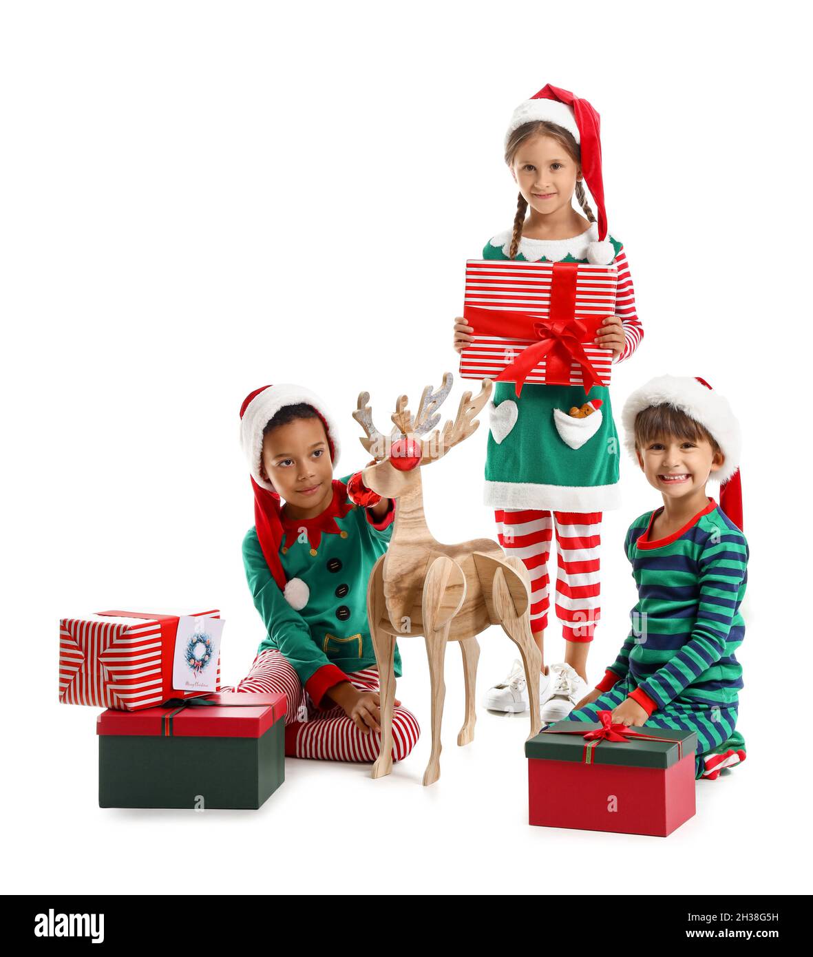Cute little children dressed as elves with Christmas gifts on white ...
