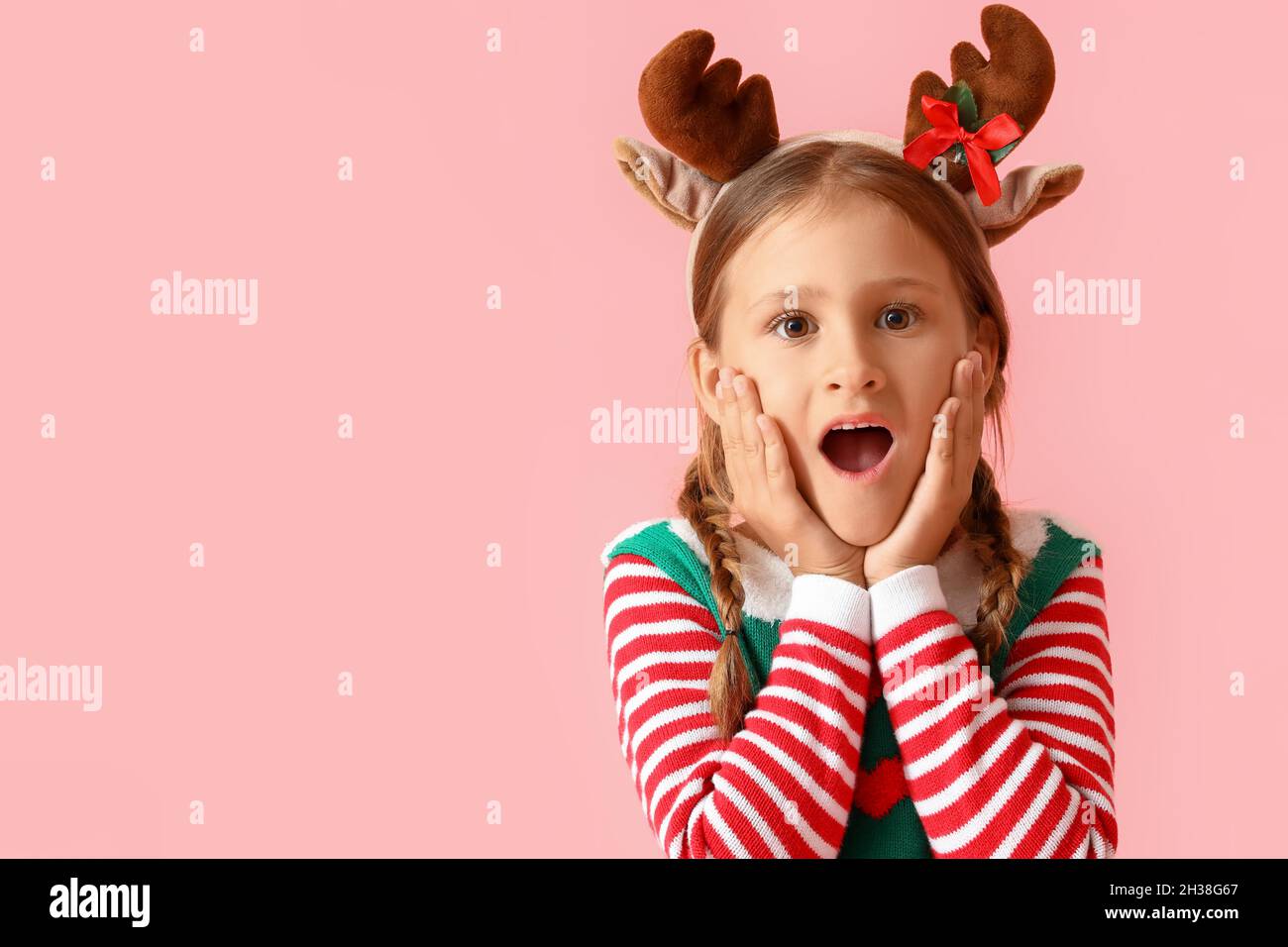 Surprised little girl dressed as elf on pink background Stock Photo - Alamy