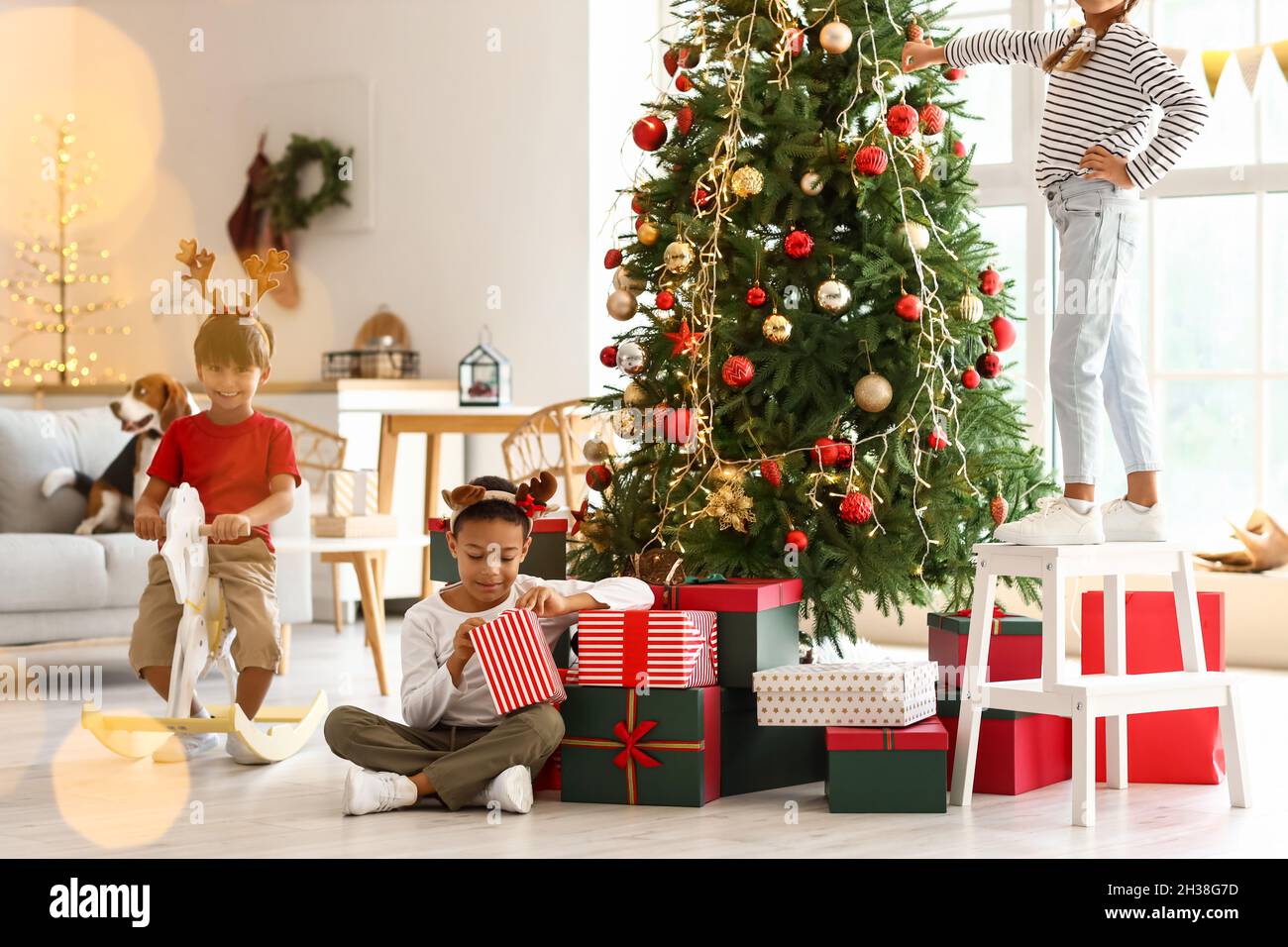 Cute little children celebrating Christmas at home Stock Photo - Alamy
