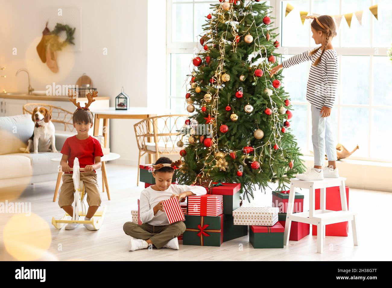 Cute little children celebrating Christmas at home Stock Photo - Alamy