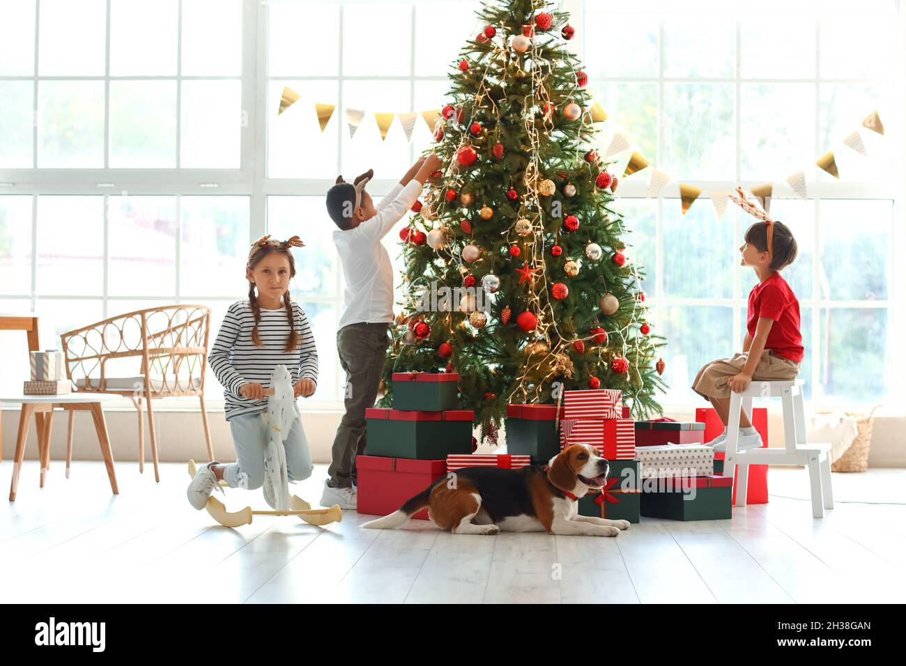 Cute little children celebrating Christmas at home Stock Photo - Alamy