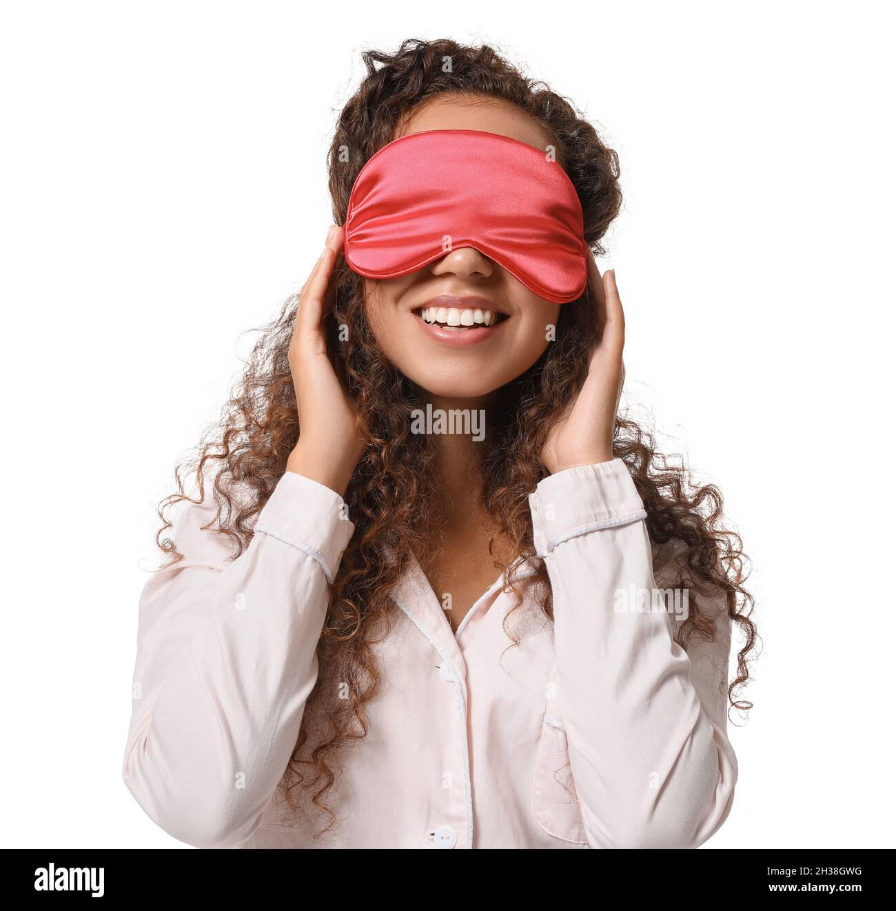 Young African-American woman with red sleeping mask on white background ...