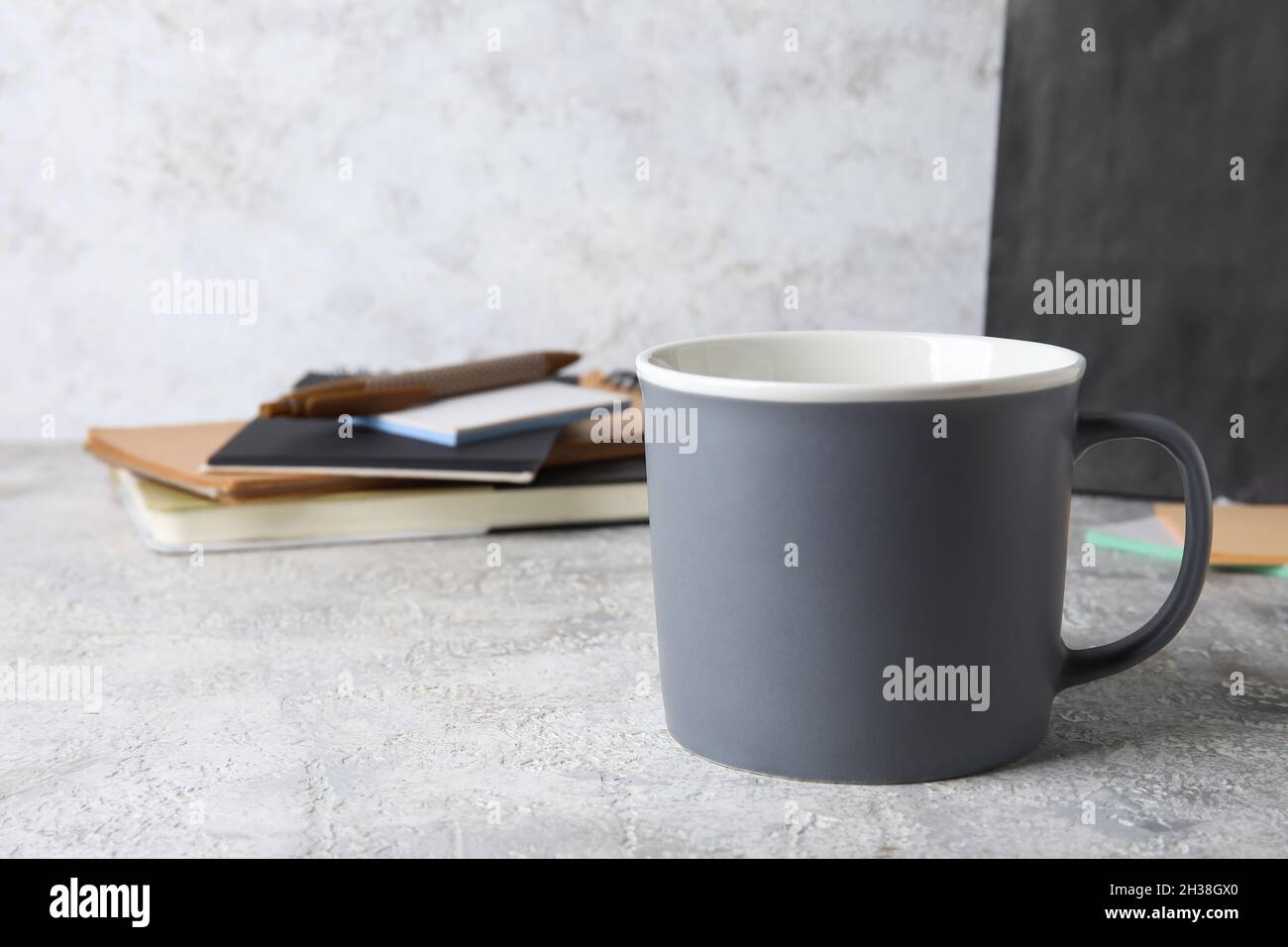 Stylish grey cup on light background Stock Photo - Alamy