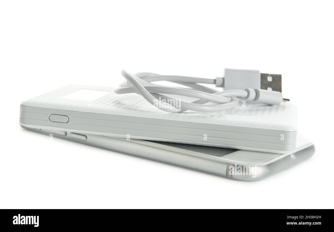 Modern power bank and mobile phone on white background Stock Photo - Alamy