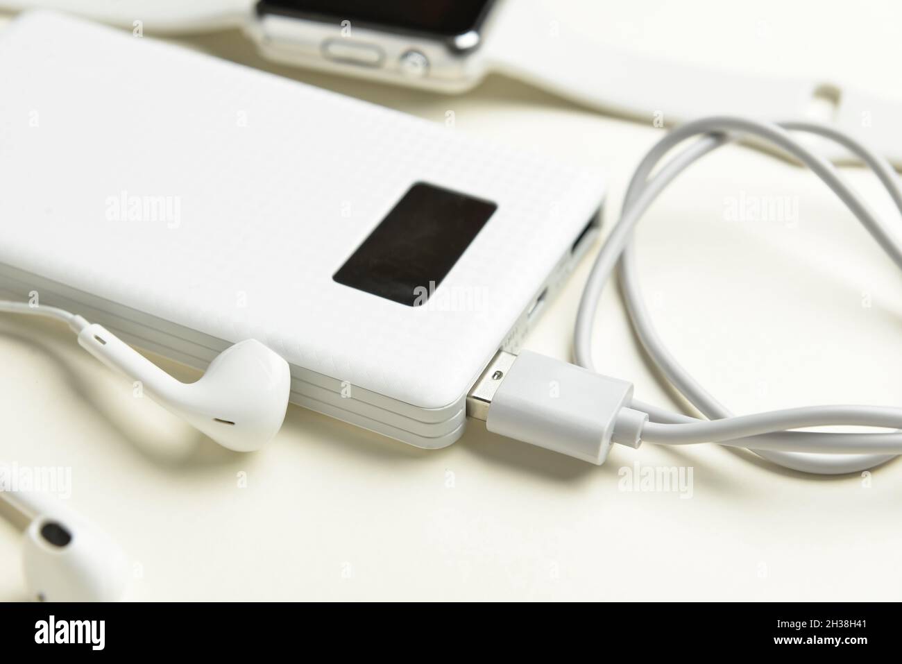Modern power bank and earphones on beige background, closeup Stock ...