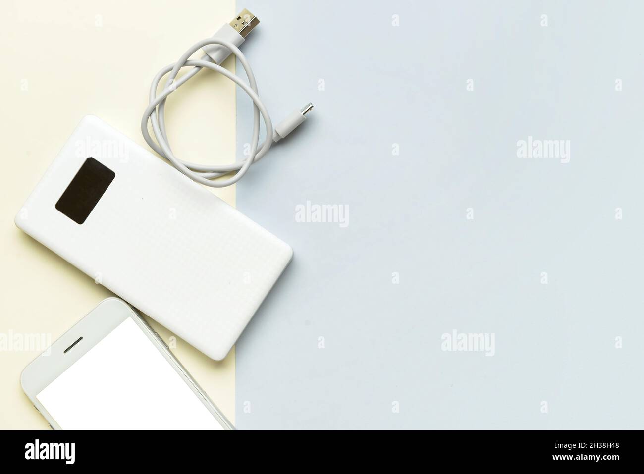Modern power bank and mobile phone on color background Stock Photo - Alamy