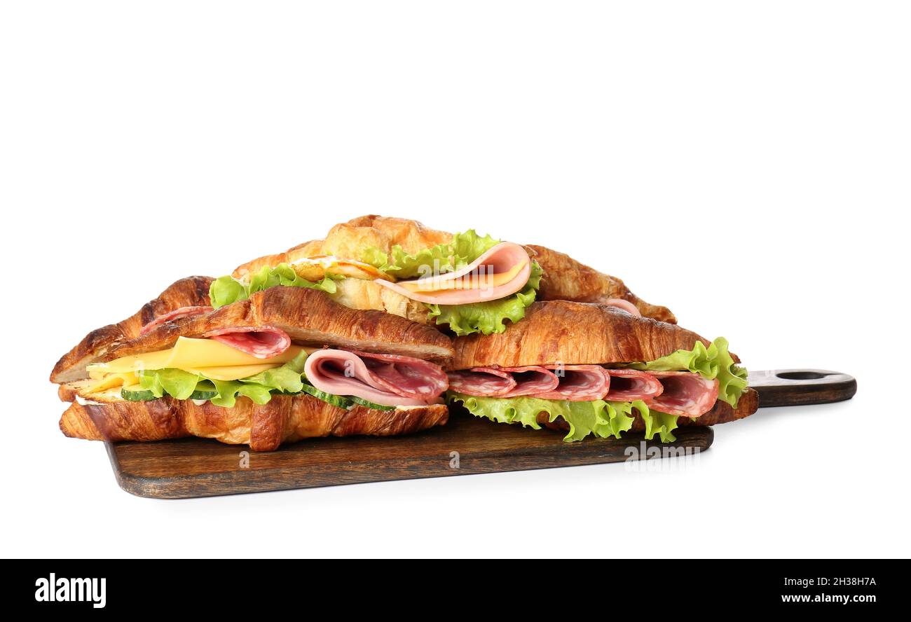 Wooden board with delicious croissant sandwiches on white background ...