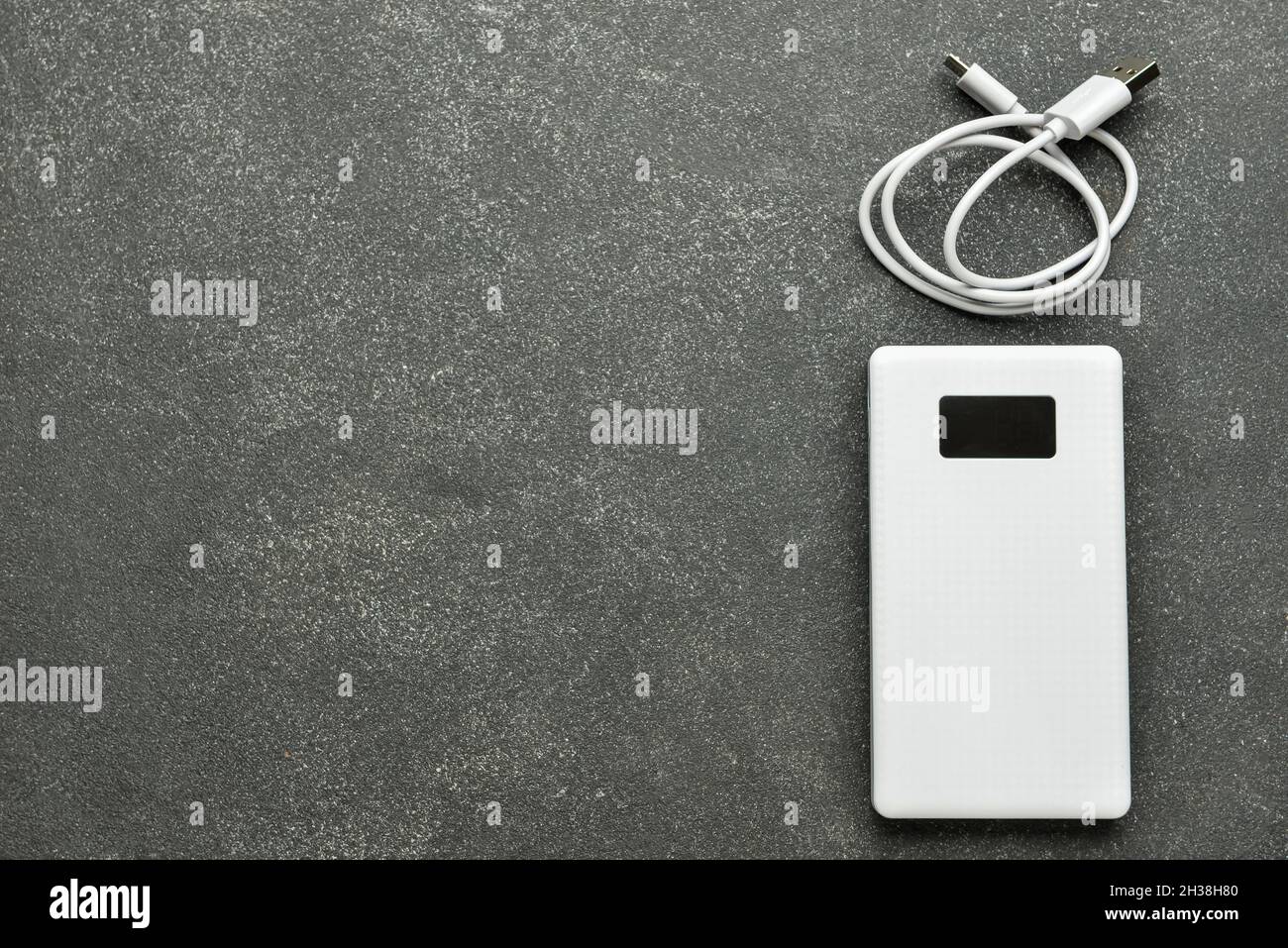 Modern power bank and USB cable on black background Stock Photo - Alamy