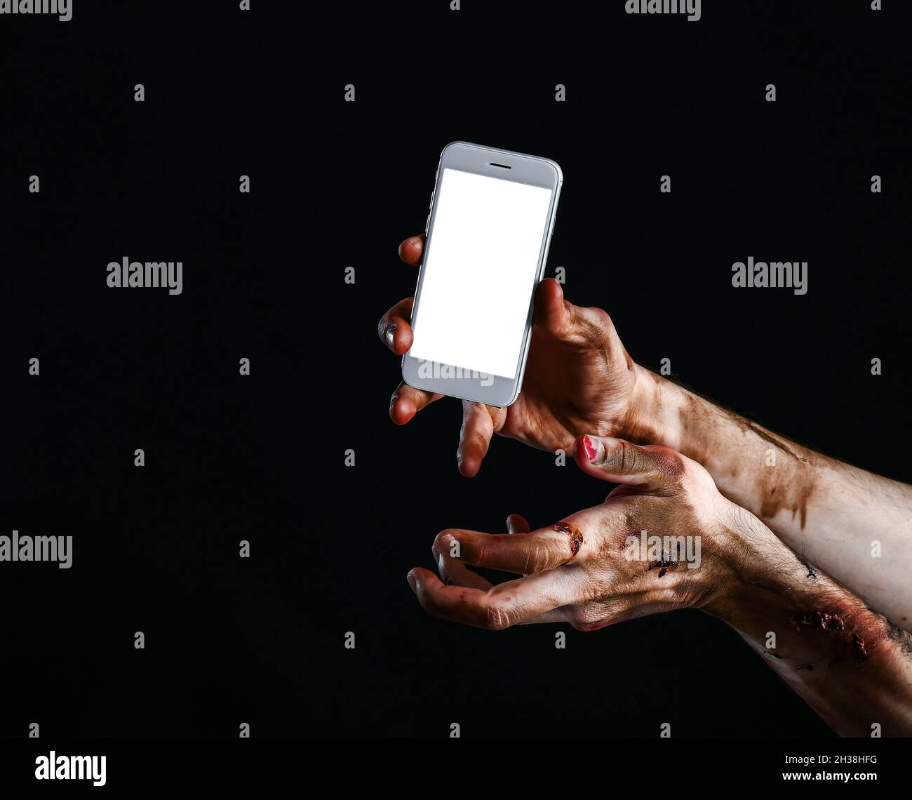 Hands of zombie with mobile phone on dark background Stock Photo - Alamy