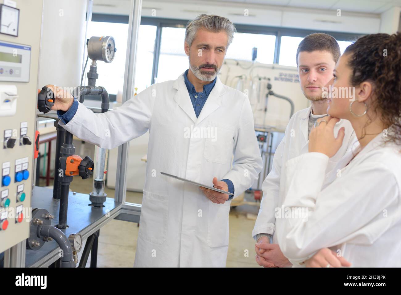 teacher explaining control panel to students Stock Photo - Alamy