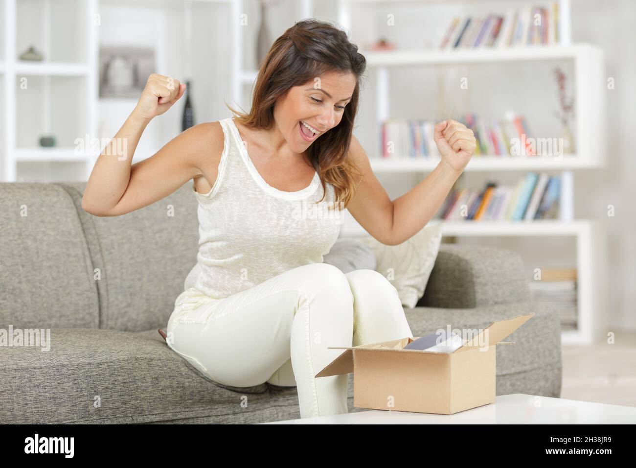 happy woman with product parcel box at home Stock Photo - Alamy