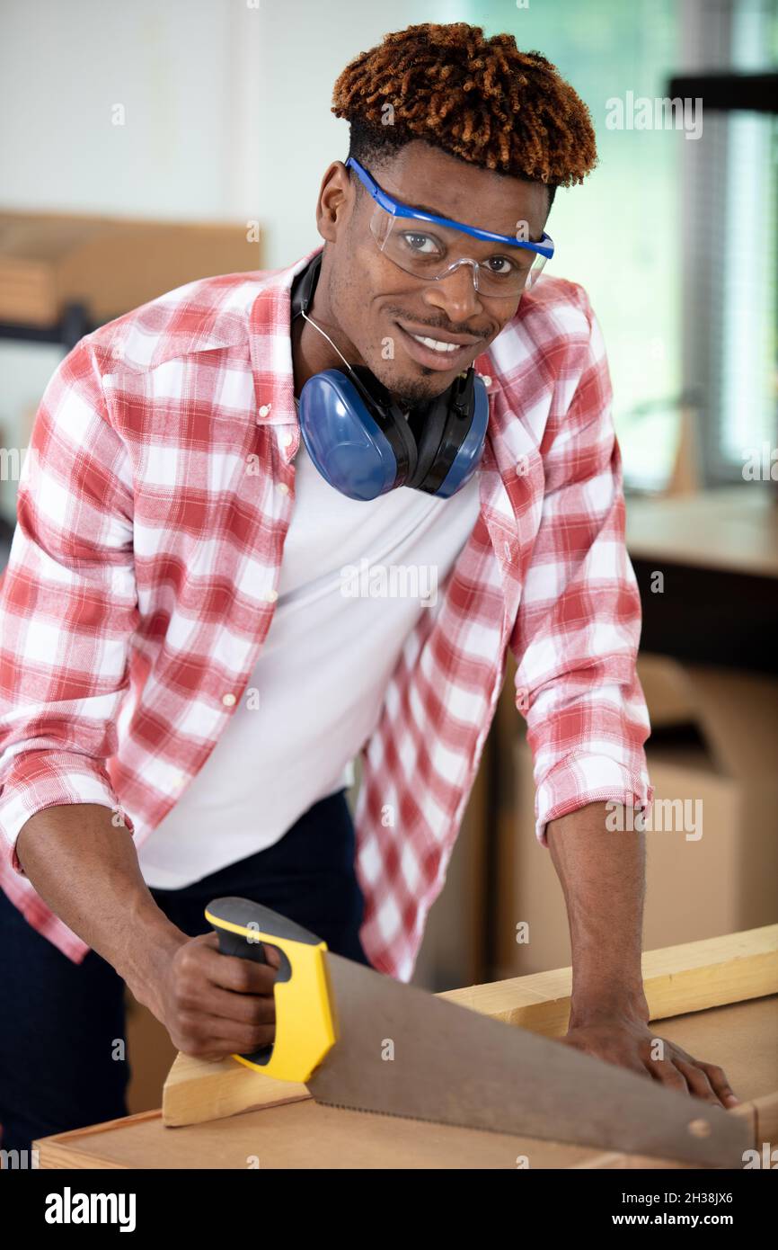 young black carpenter at work smiling Stock Photo - Alamy