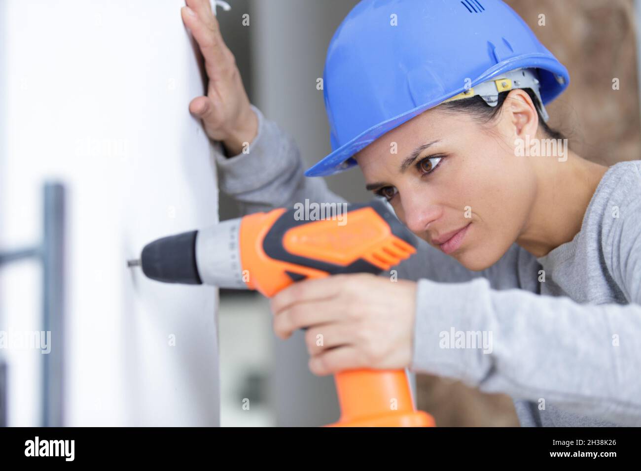 confident happy female builder with drill tool Stock Photo - Alamy