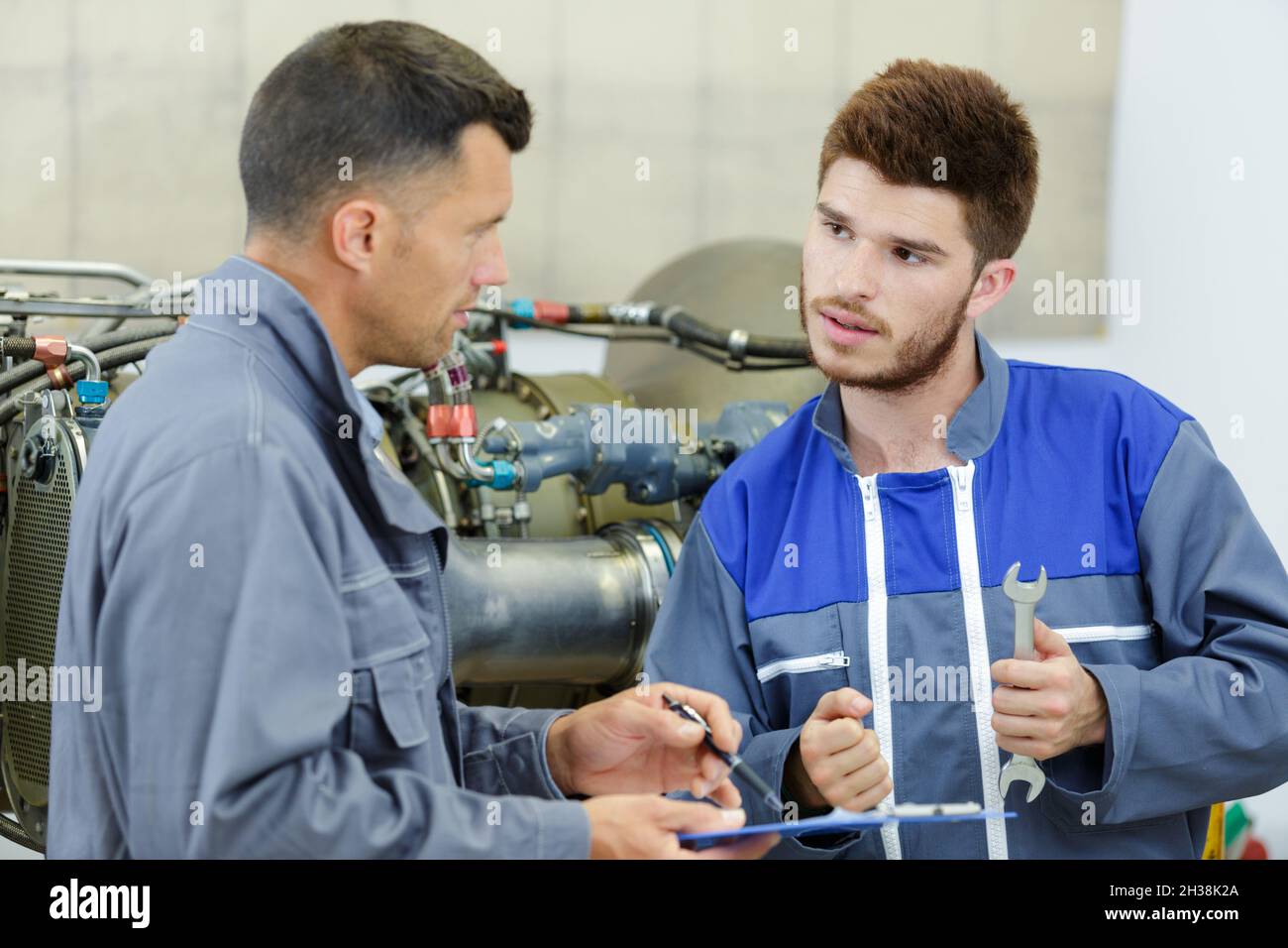 two engineers working on engine Stock Photo - Alamy