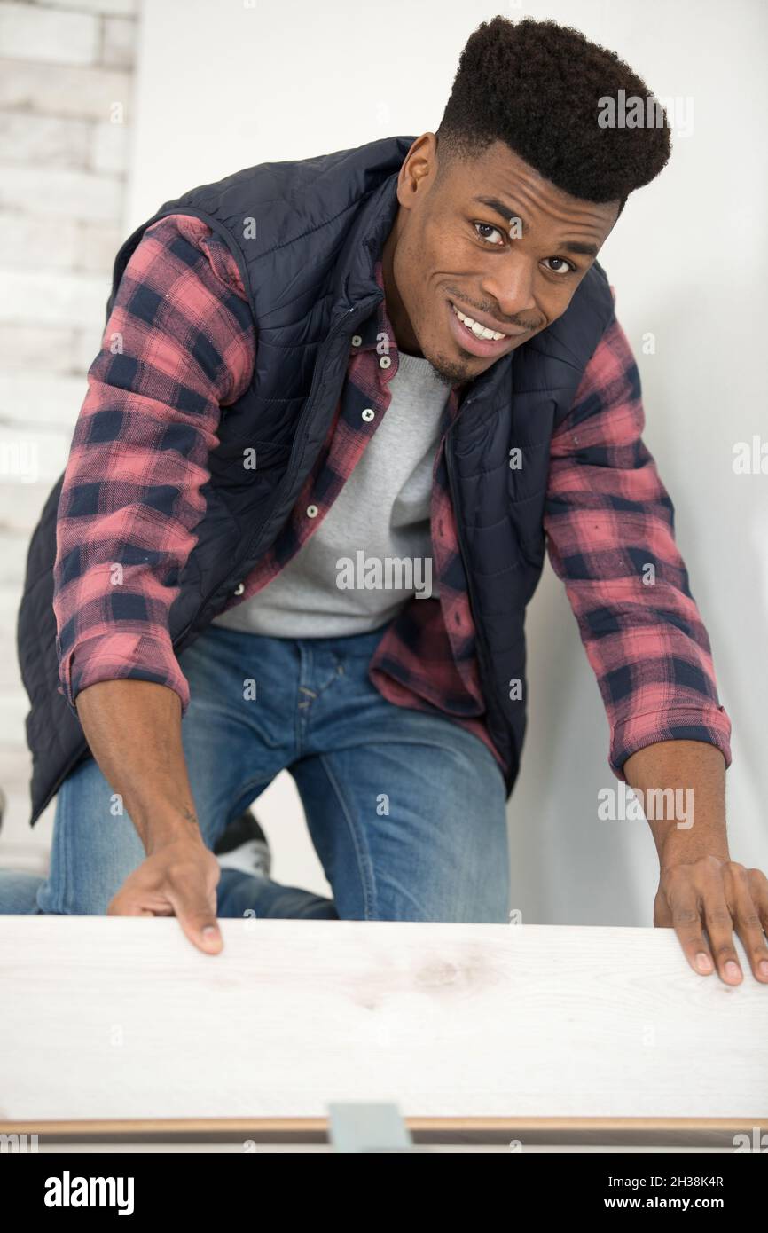 man carpenter installing a wood floor Stock Photo - Alamy