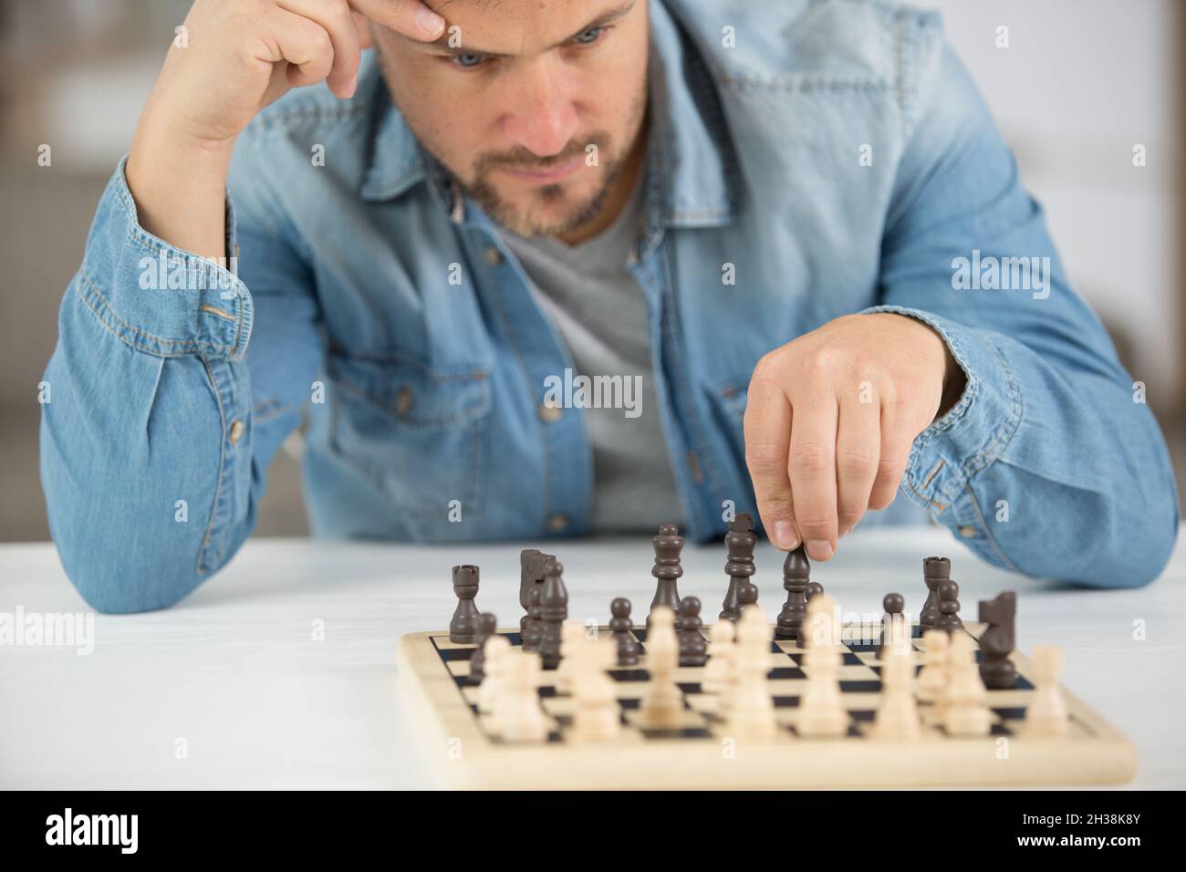 man moving a chess piece Stock Photo - Alamy
