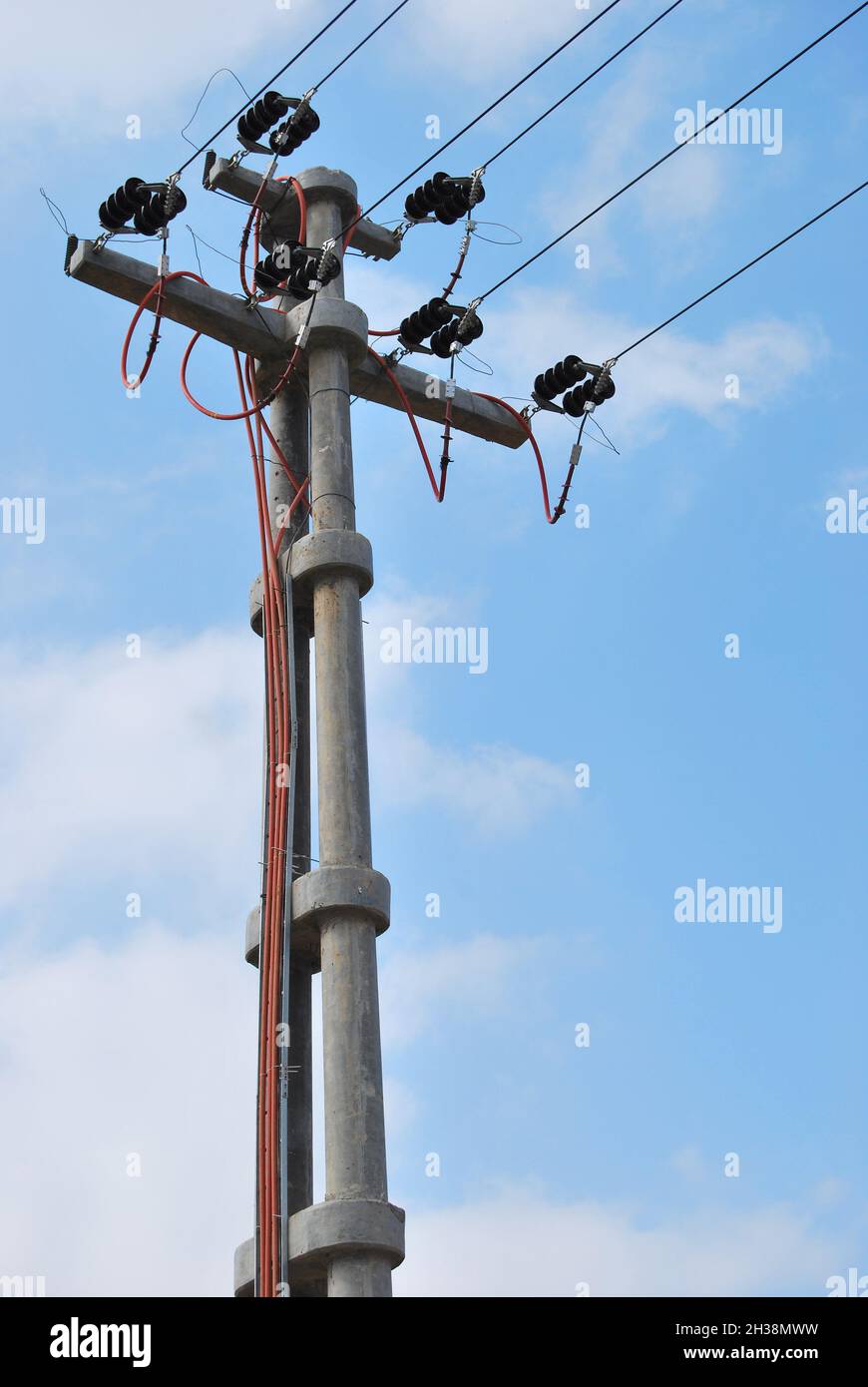 High voltage electricity cables detail over a clean blue sky, high ...