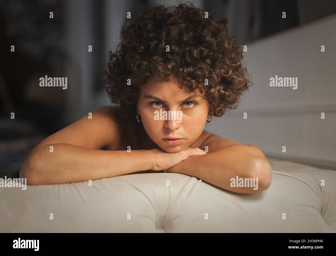 portrait of young woman on sofa Stock Photo - Alamy