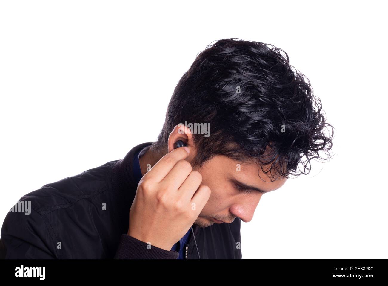 Man putting on headphones isolated on white background. Young latino ...