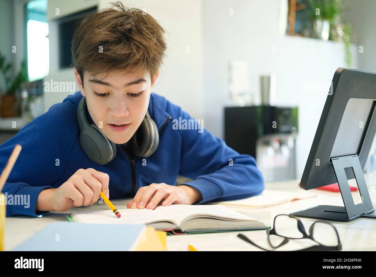 Student boy with tablet computer learning at home Stock Photo - Alamy