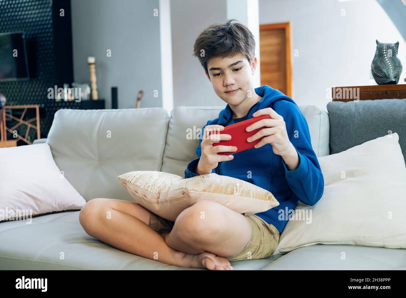 Boy playing game on mobile hi-res stock photography and images - Alamy