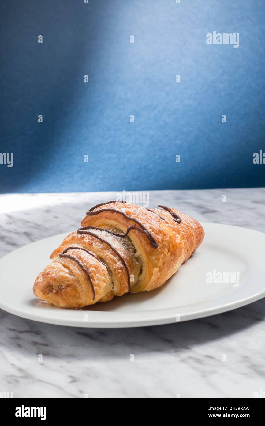 fresh croissant on the blue background Stock Photo - Alamy