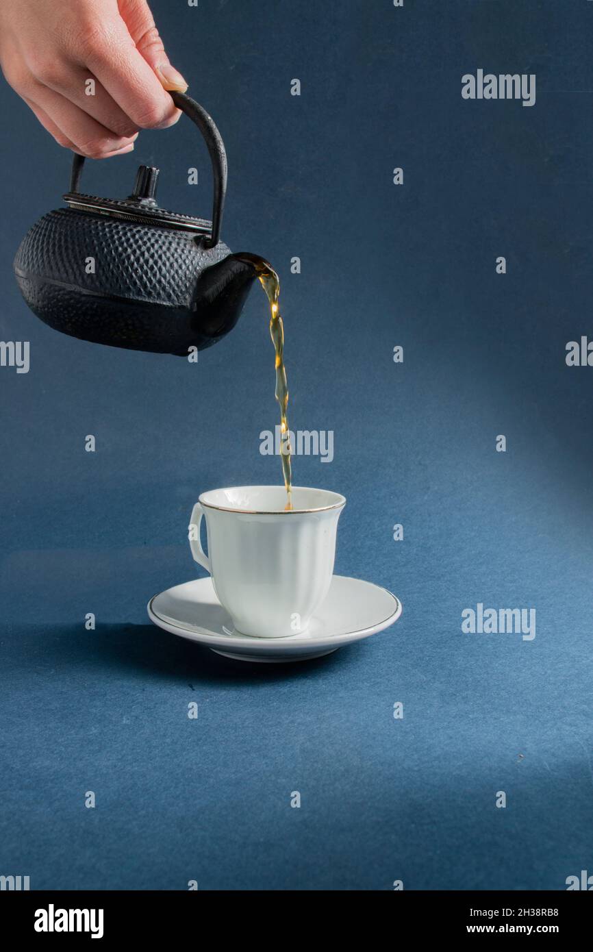 Tea falling on the cup Stock Photo - Alamy