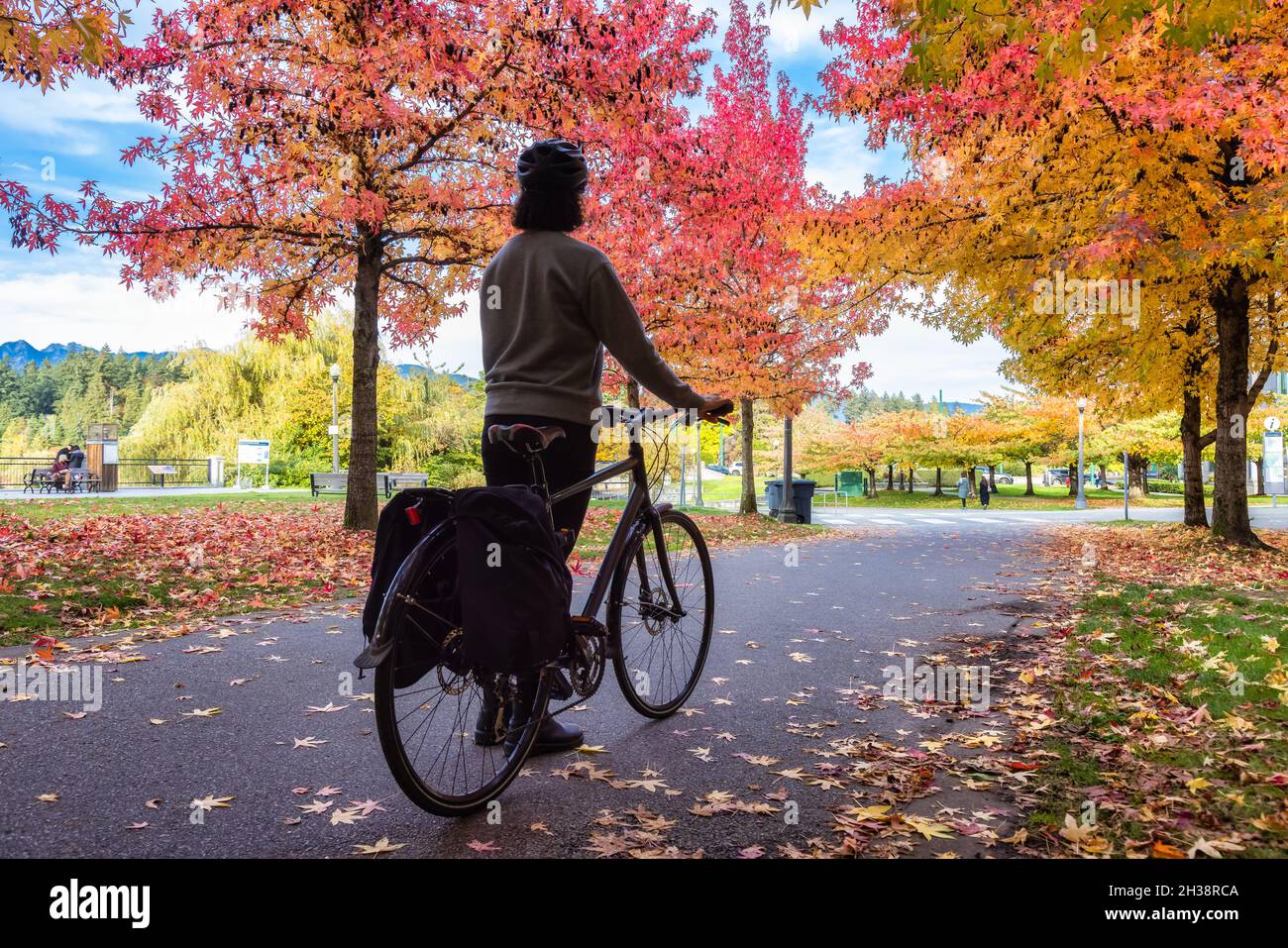 Adult Woman with bicycle on Bike Path in Stanley Park Stock Photo - Alamy