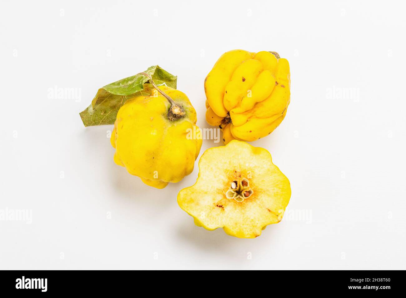 Ripe whole and cut quince isolated on white background. Fresh fruit, an ...