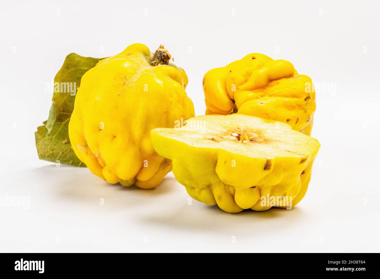 Ripe whole and cut quince isolated on white background. Fresh fruit, an ...