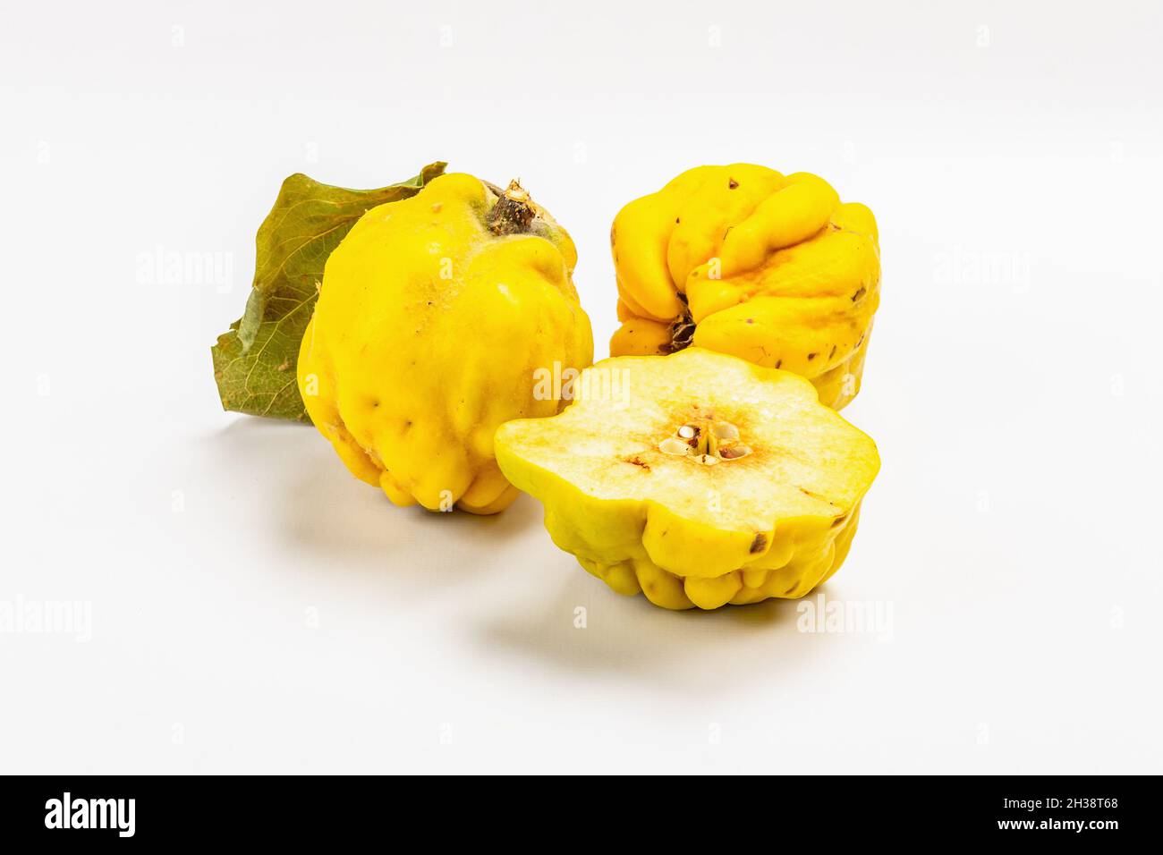 Ripe whole and cut quince isolated on white background. Fresh fruit, an ...