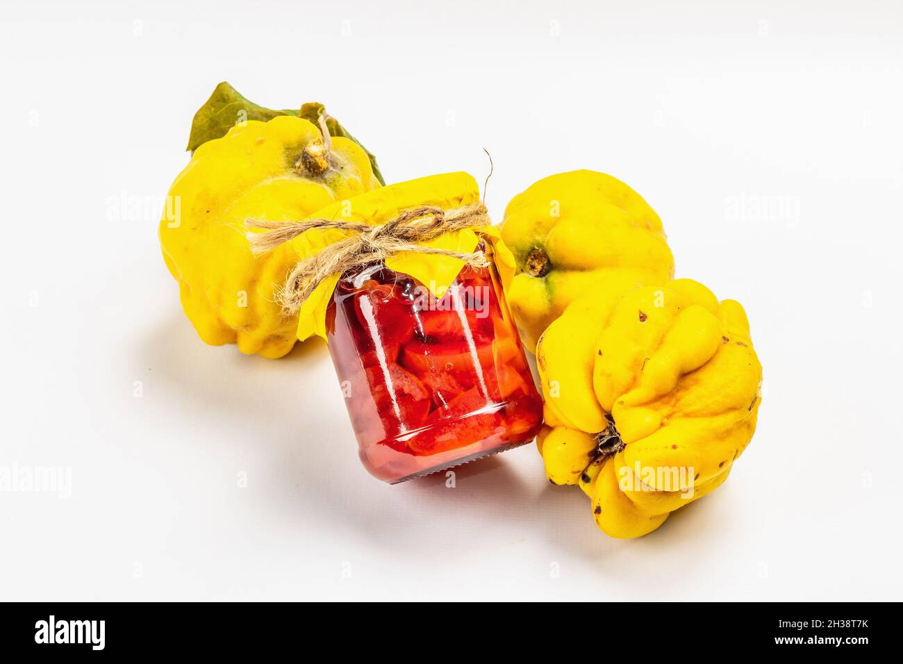 Ripe whole quince and sweet jam from it isolated on white background ...