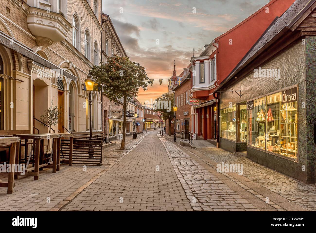 the shopping street in Ystad an early morning at sunrise with ...