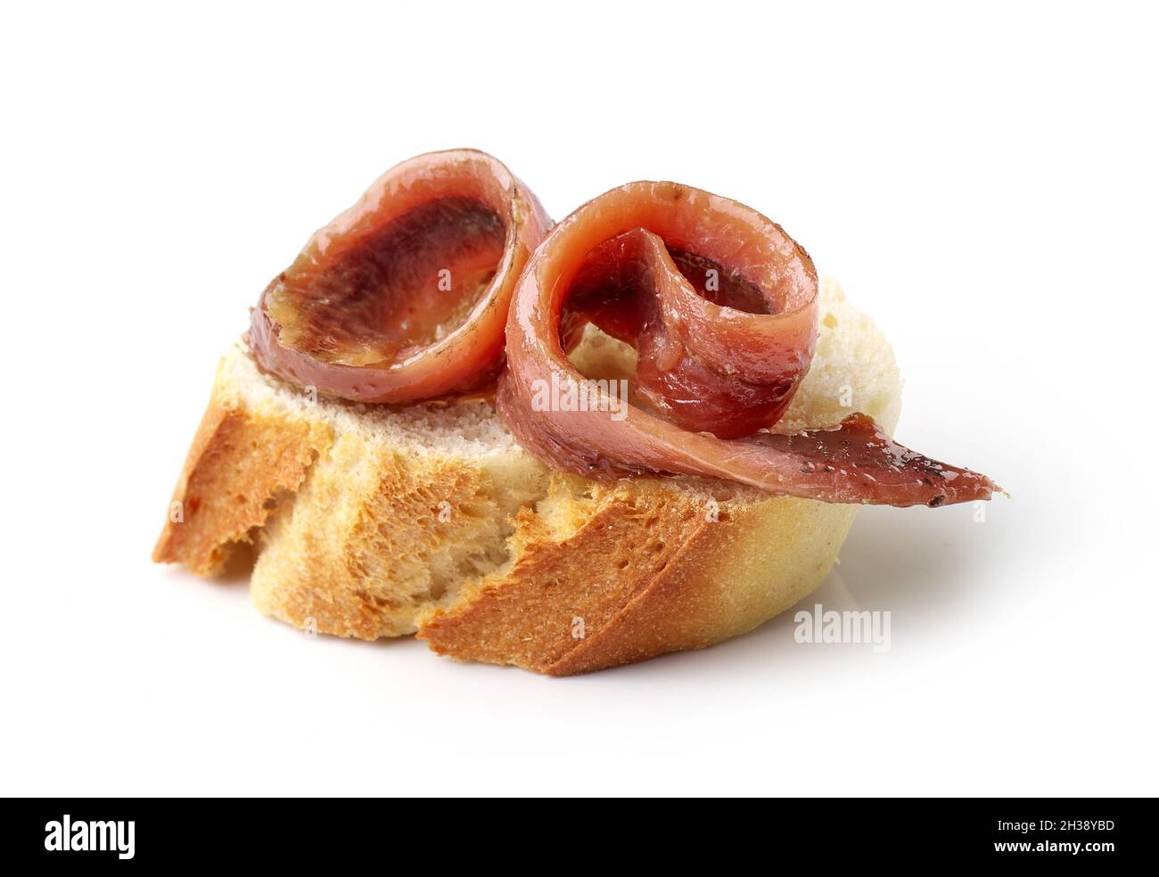 canned anchovy fillets on slice of bread isolated on white background ...