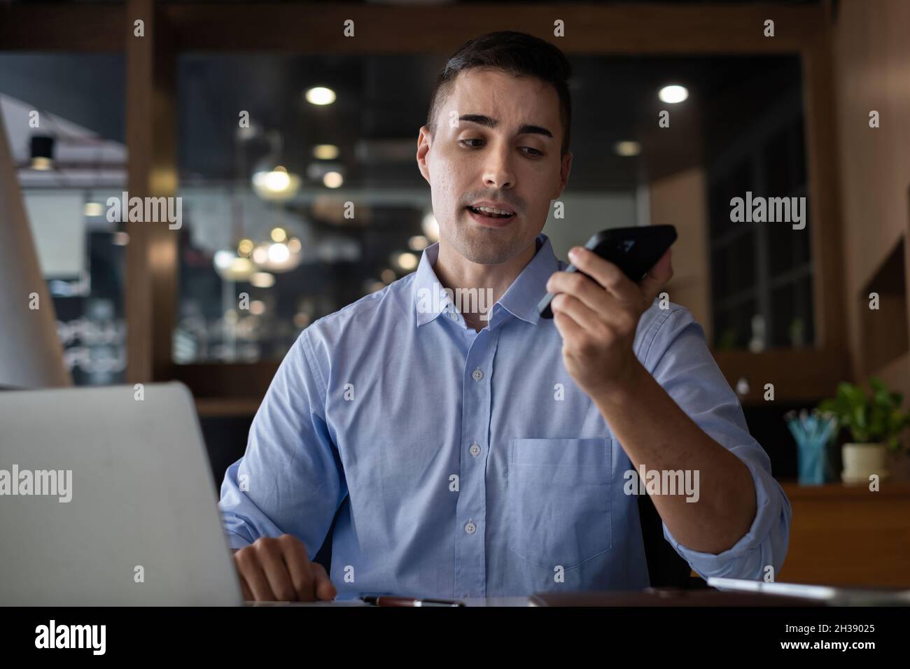 American employee talking with speaker phone and video call by ...