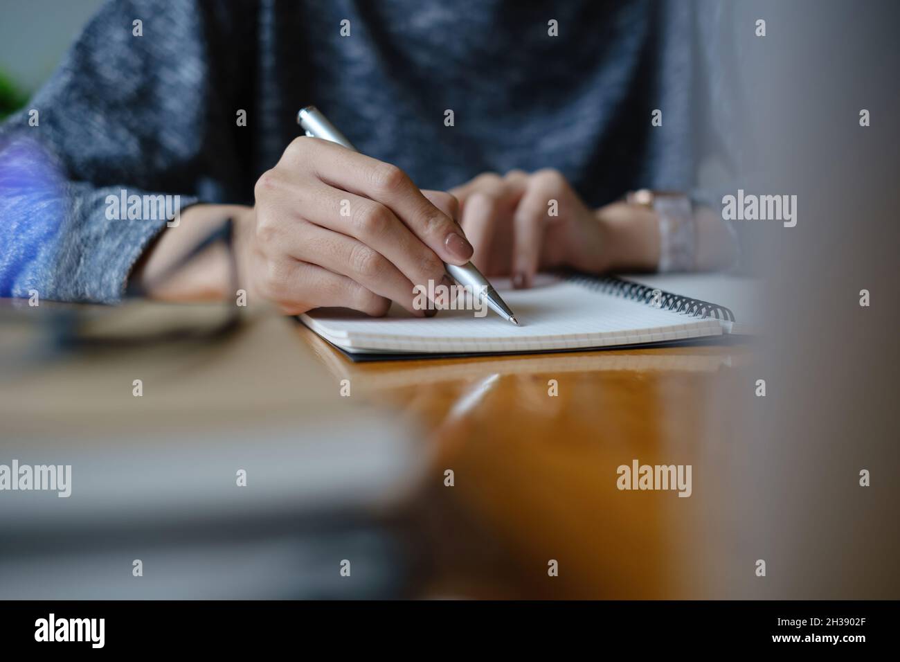Young female college taking notes and using highlighter. Focused ...