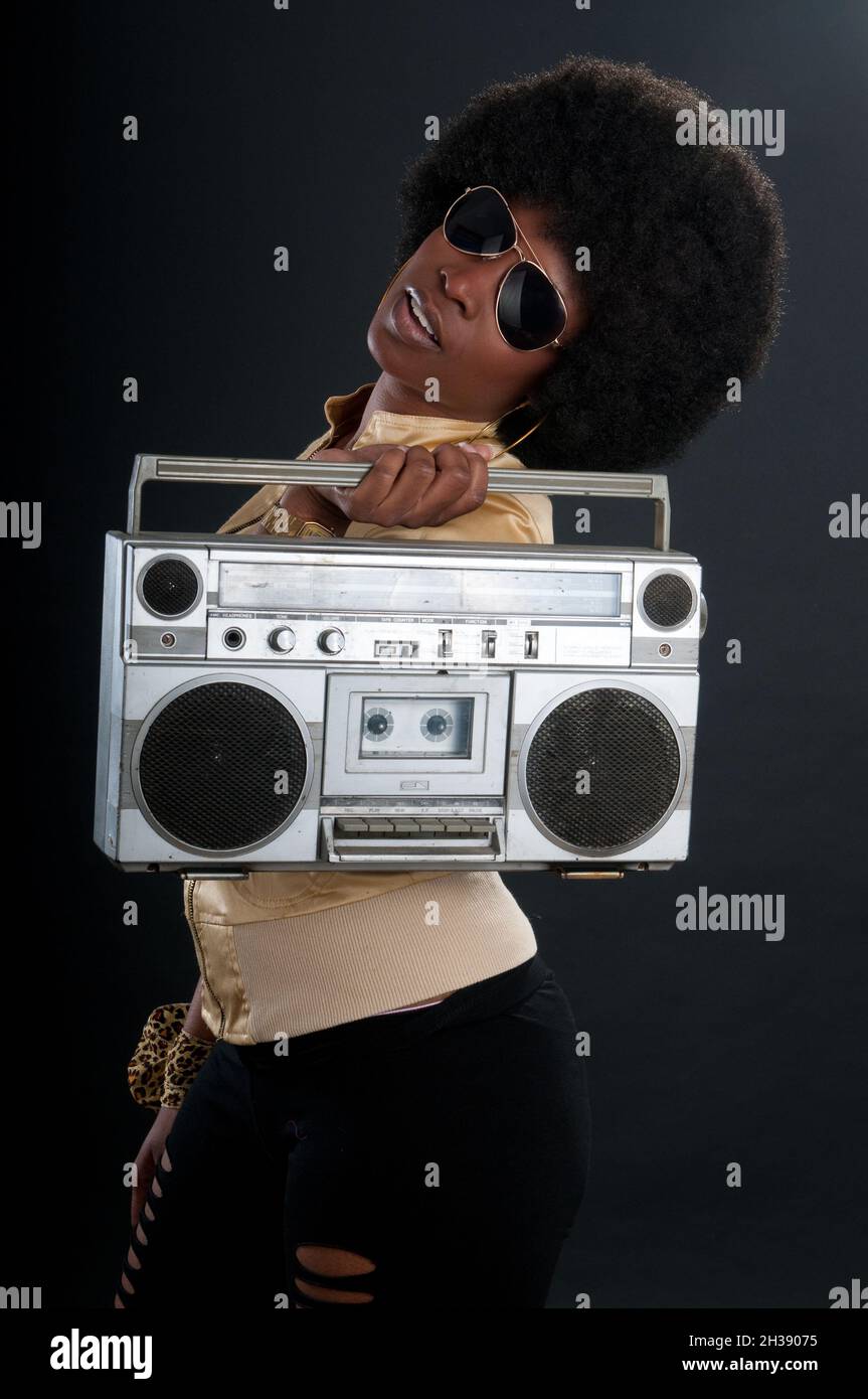 retro looking african american singer sitting on cassette tape player ...