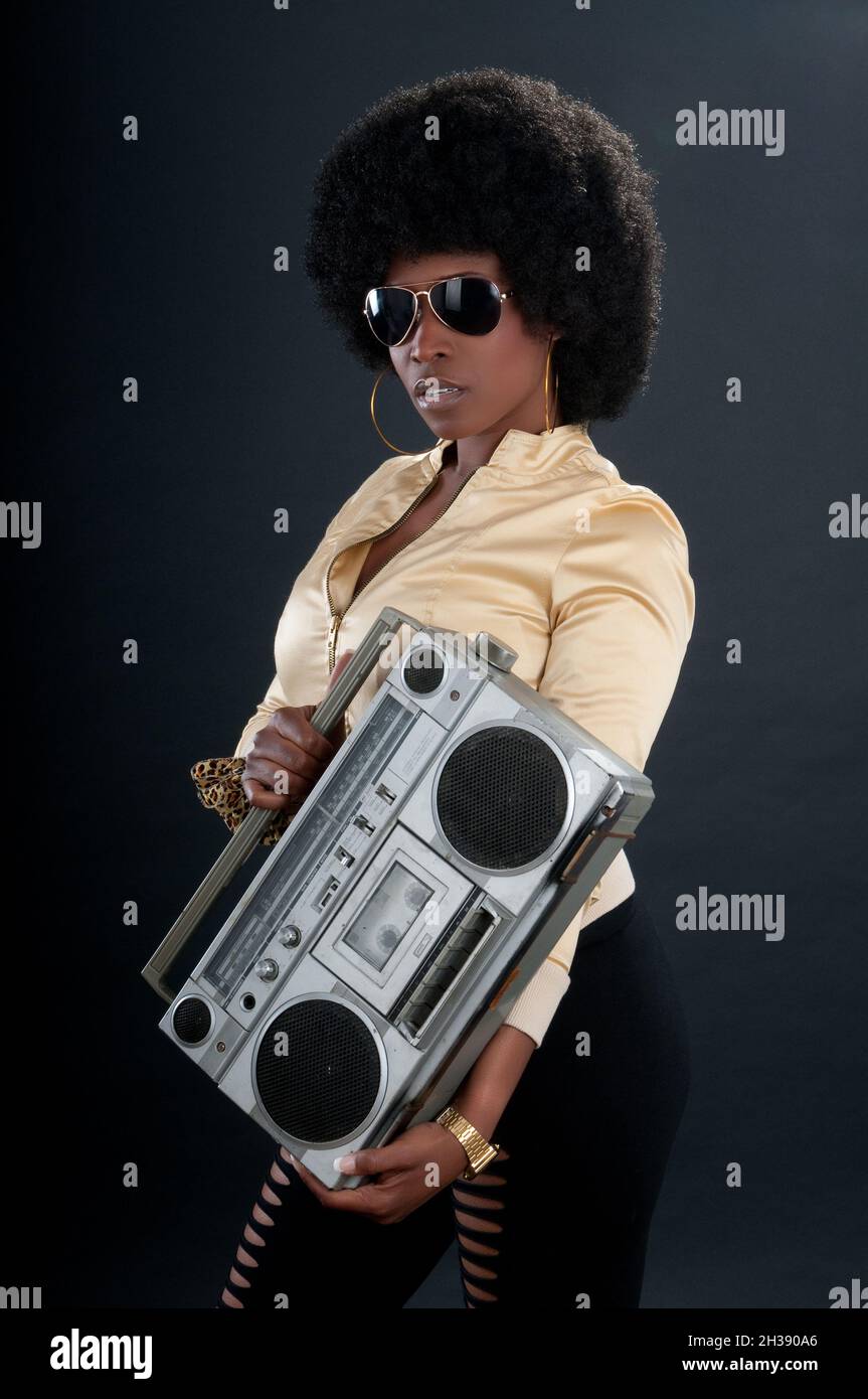 retro looking african american singer sitting on cassette tape player ...