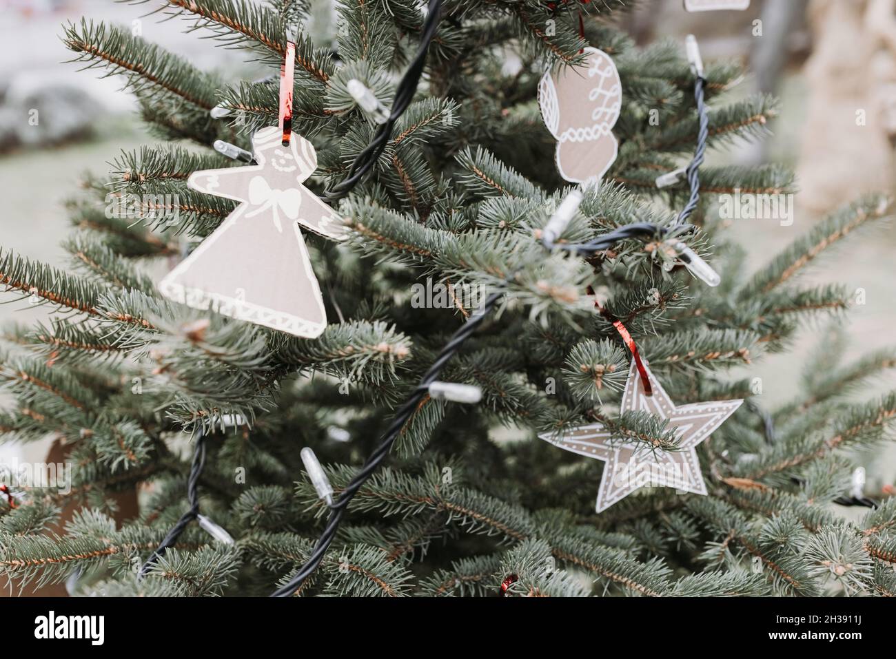 Handmade brown cardboard paper Christmas decorations on Christmas tree ...