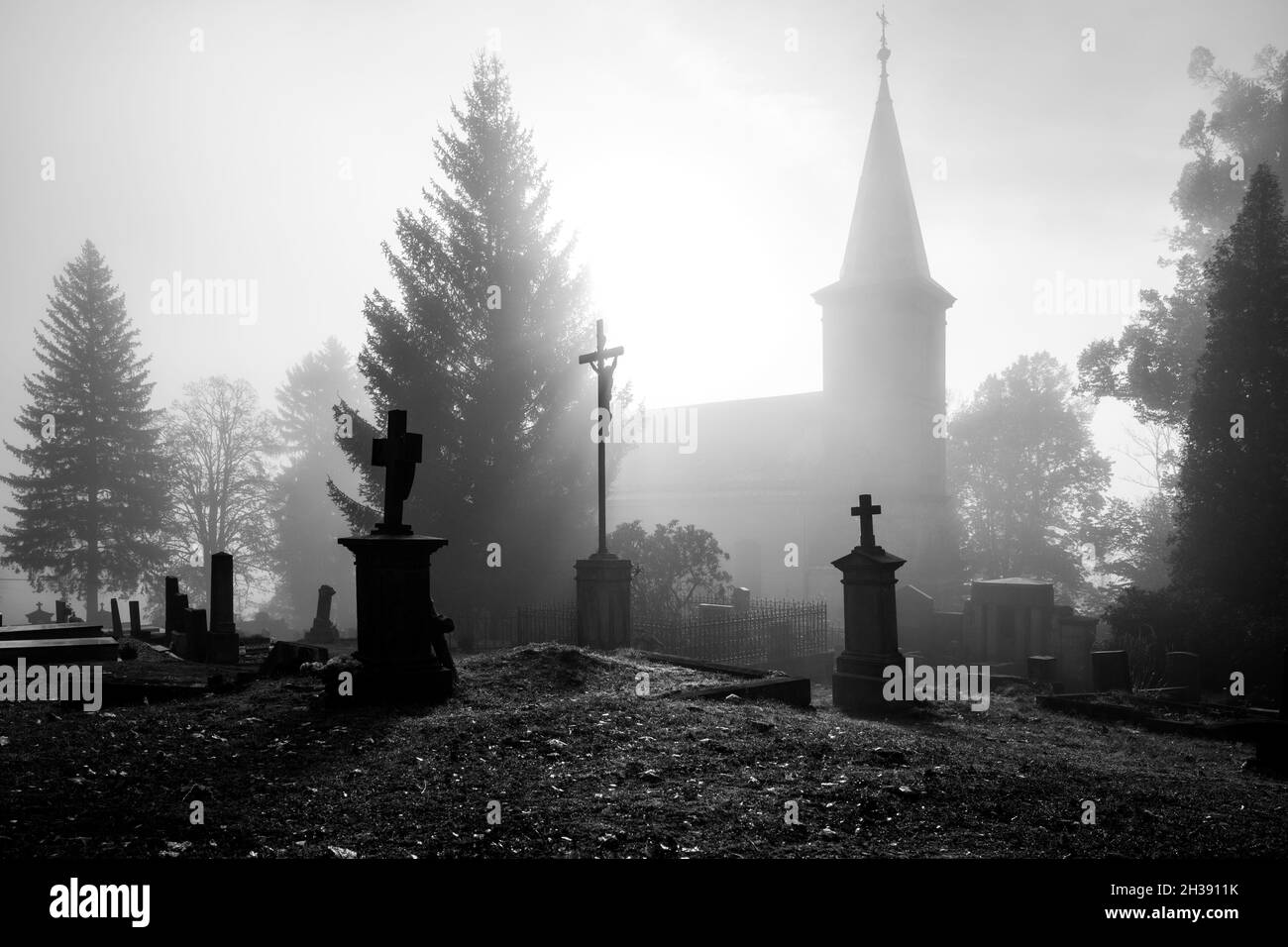 Spooky grave yard with and old church Stock Photo - Alamy