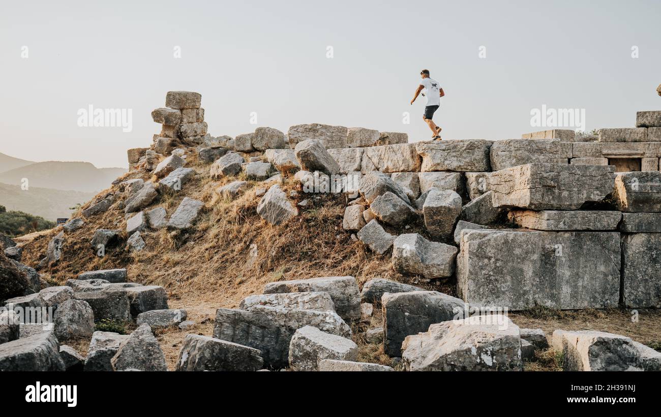 Tourist on top of old blocks in Arcadian Gate Ruins in Ancient Messini ...
