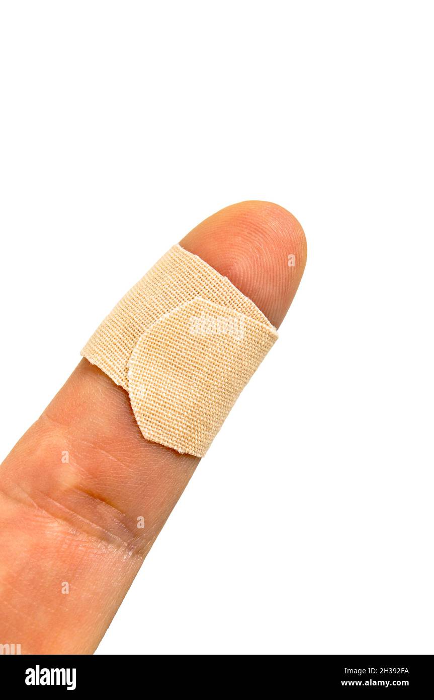 Beige band aid plaster of cloth wrapped in an injured thumb Stock Photo Alamy